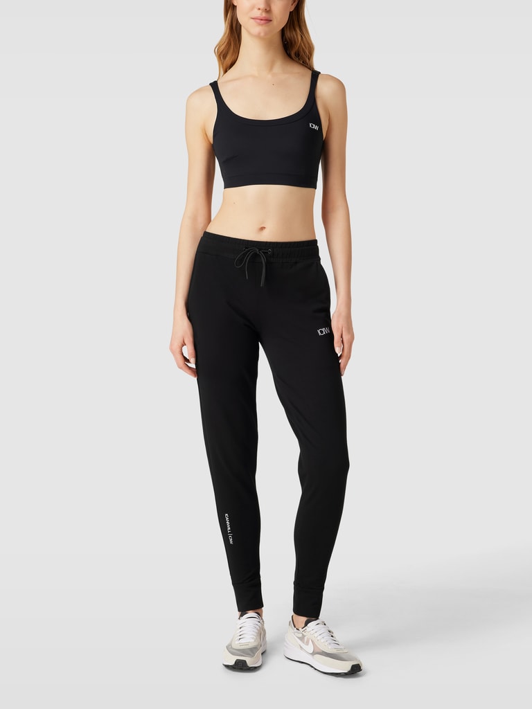 Kup online ICANIWILL Spodnie dresowe z nadrukiem z logo (czarny)